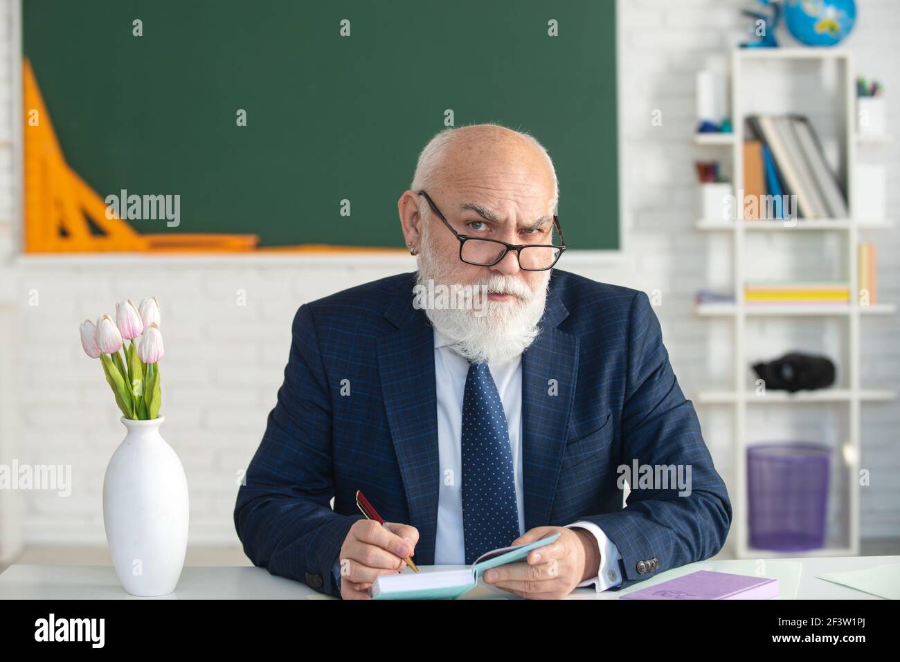 Professor holding a book and pointing with a wooden stick isolated on ...