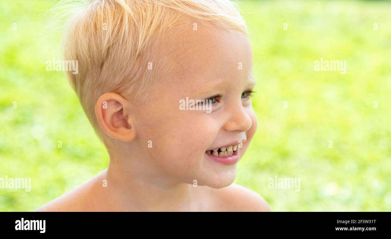 Cute kids face. Closeup portrait of smiling child boy on green ...