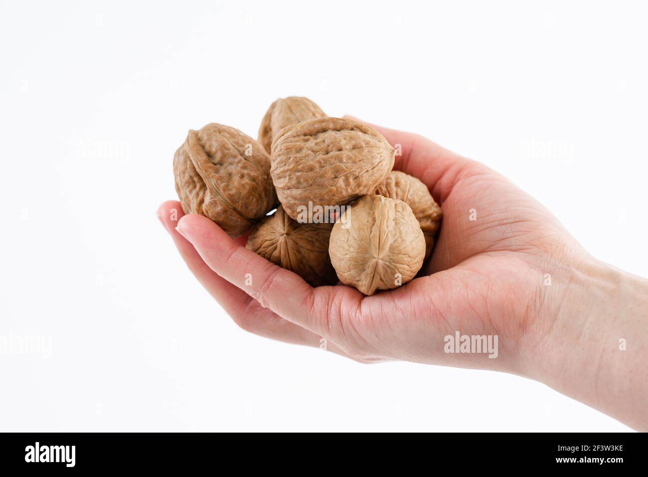 Walnuts and hands hi-res stock photography and images - Alamy