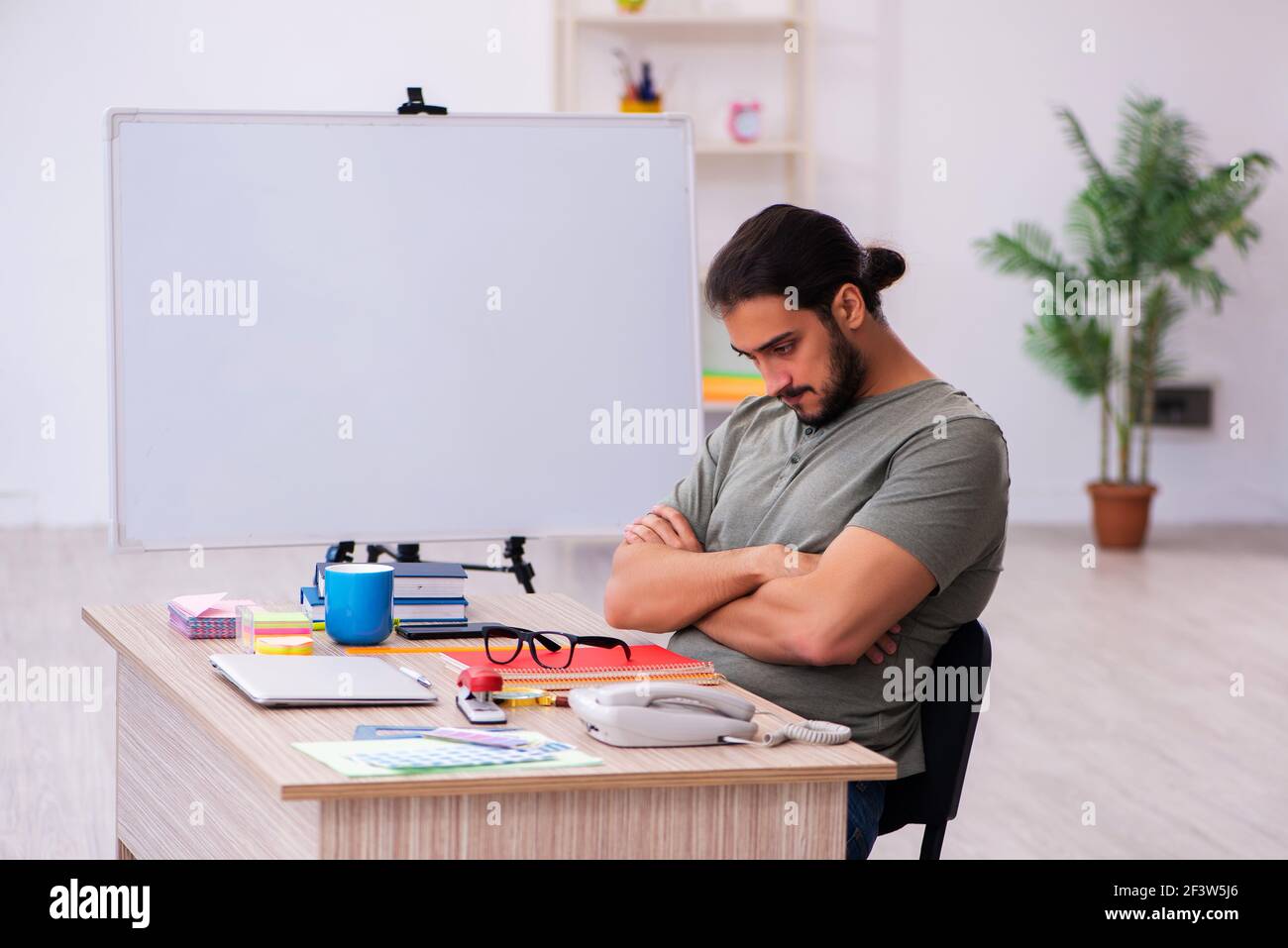 Exhausted young creative designer working hi-res stock photography and ...