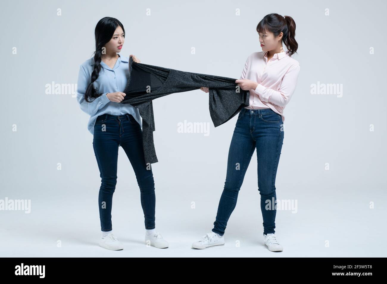 Women fighting over clothes hi-res stock photography and images - Alamy