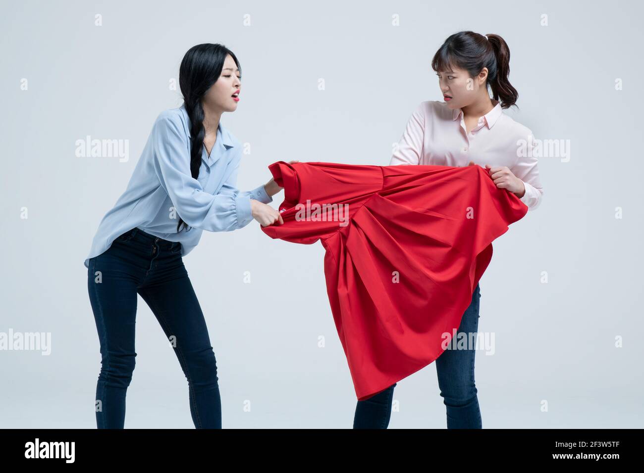 Women fighting over clothes hi-res stock photography and images - Alamy