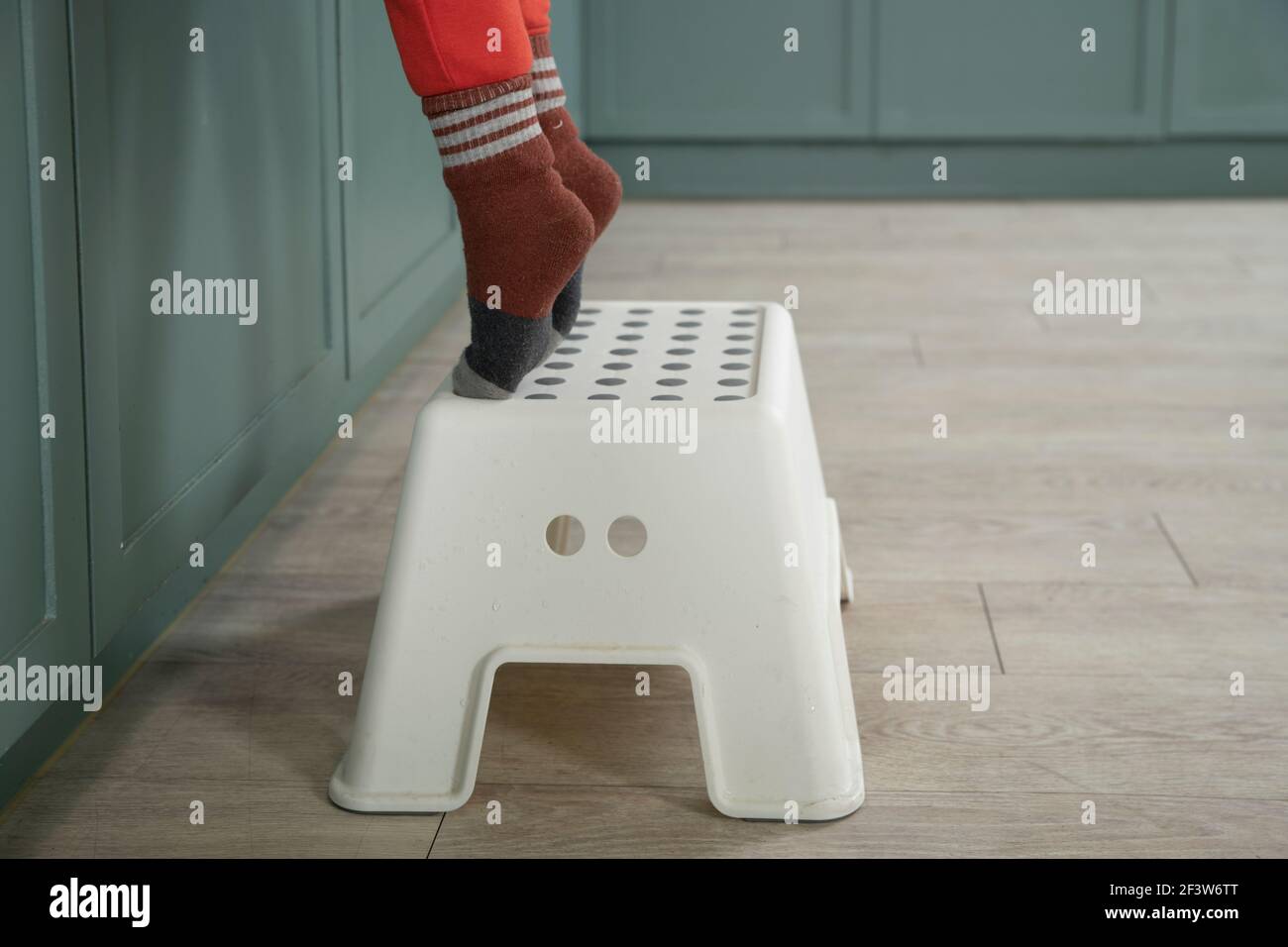 Asian child trying to cook alone in the kitchen Stock Photo - Alamy