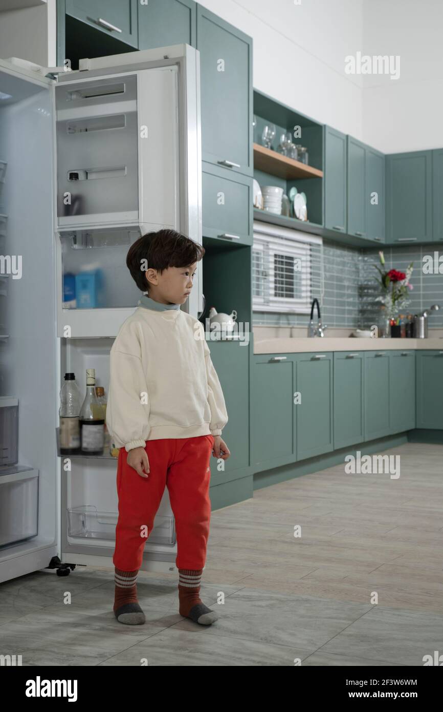 child abuse concept, Asian child with no food at home searching for ...