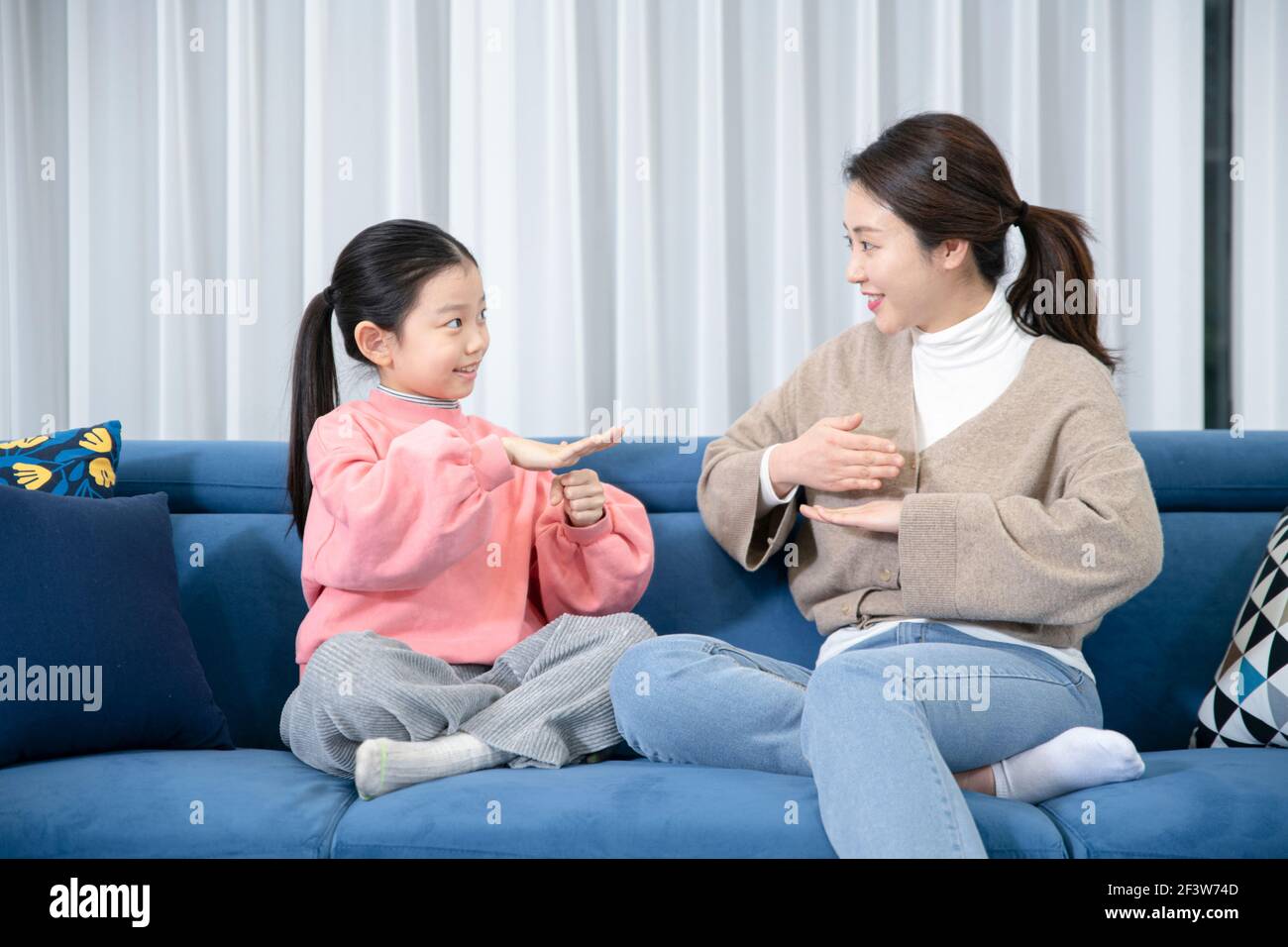 Communicating asian sign language hi-res stock photography and images ...