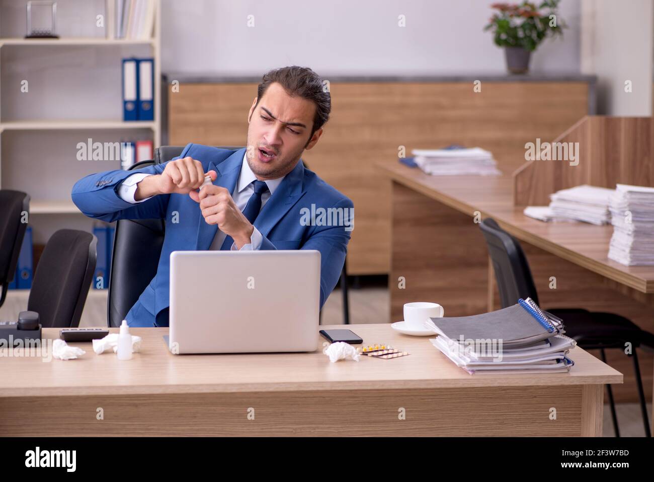 Sick businessman employee suffering at workplace Stock Photo - Alamy