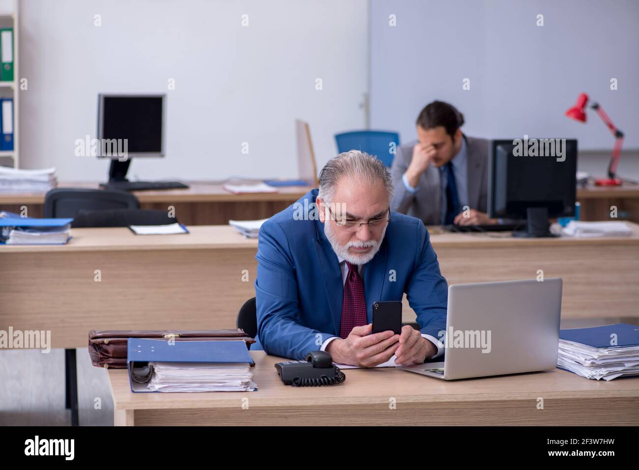 Two employees working in the office Stock Photo - Alamy