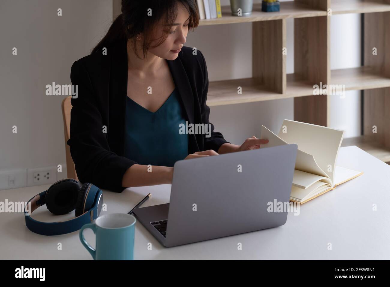 concentrated woman student busy studying using laptop make notes in ... concentrated woman student busy studying using laptop make notes in ...