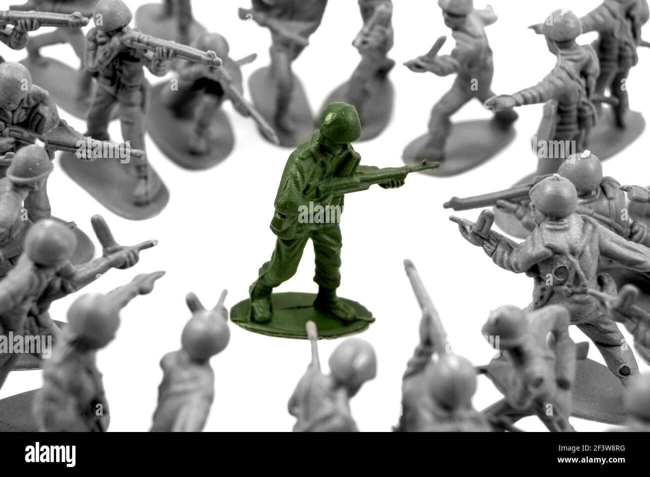 toy green army man surrounded Stock Photo - Alamy