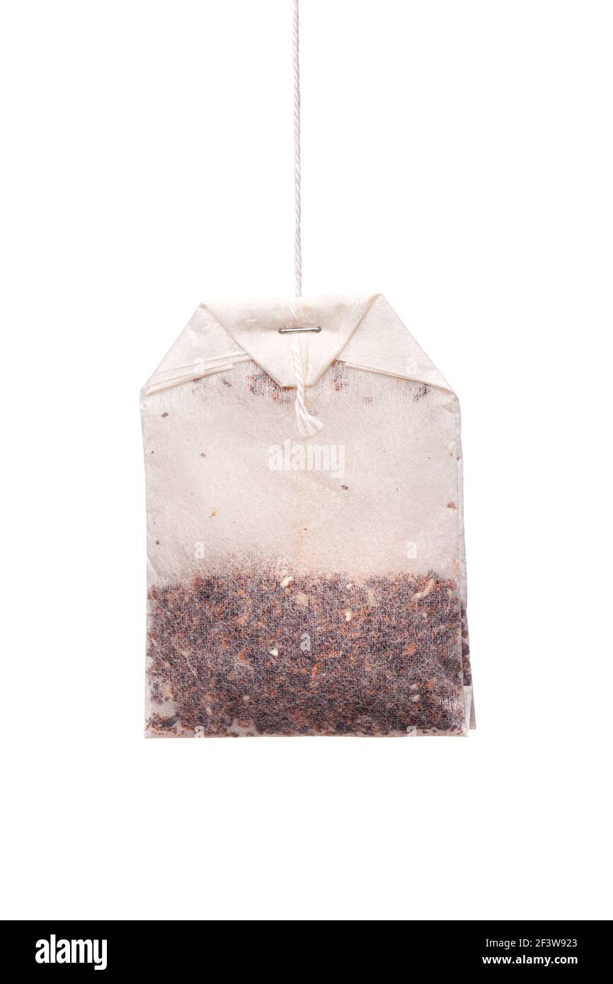 Herbal tea in paper bag. Teabag hanging against white background Stock ...