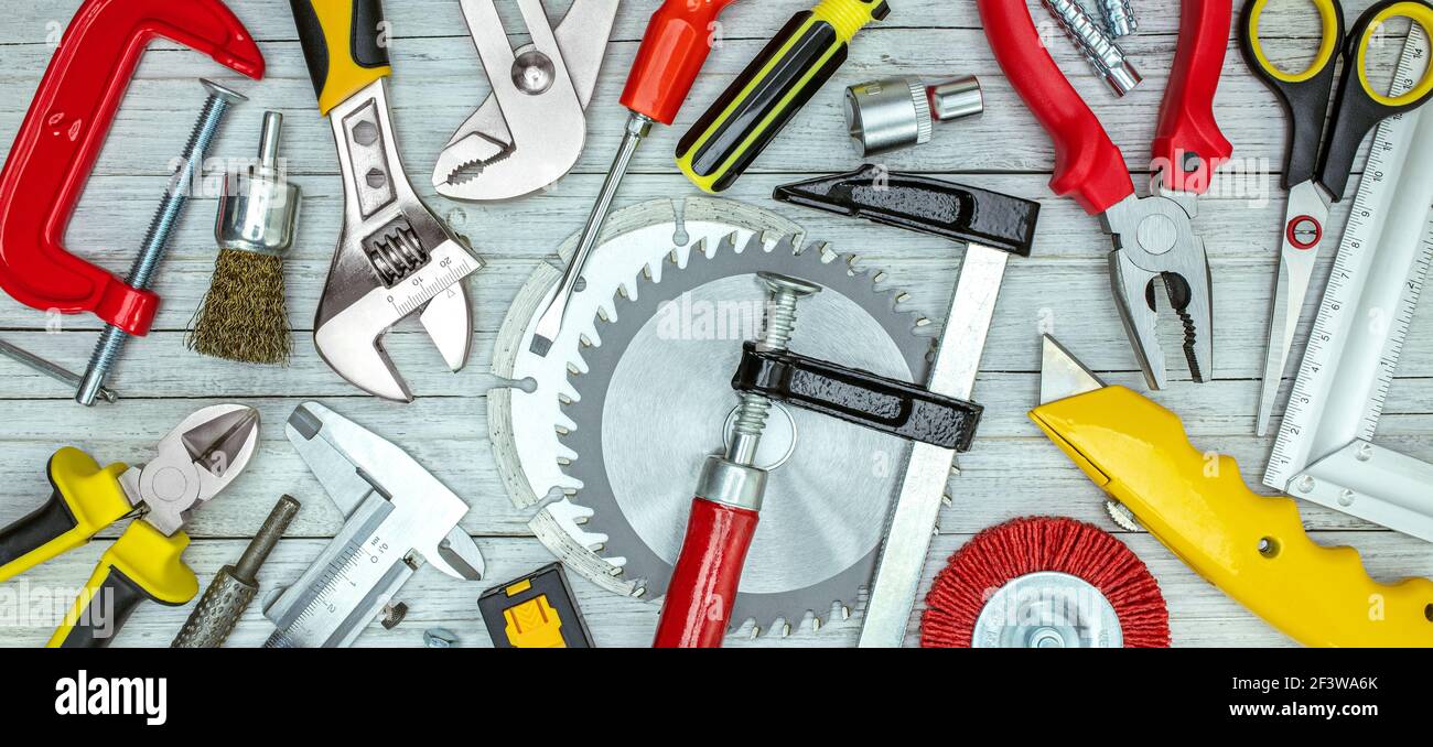 set of hand tools on grey background including wrenches, calipers ...