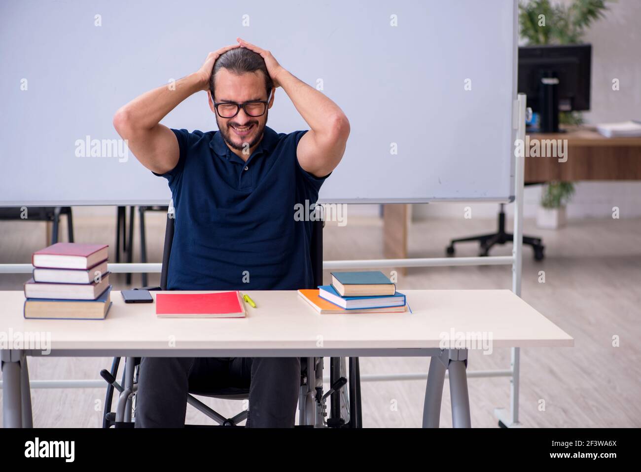 Young handicapped student in the classroom Stock Photo - Alamy