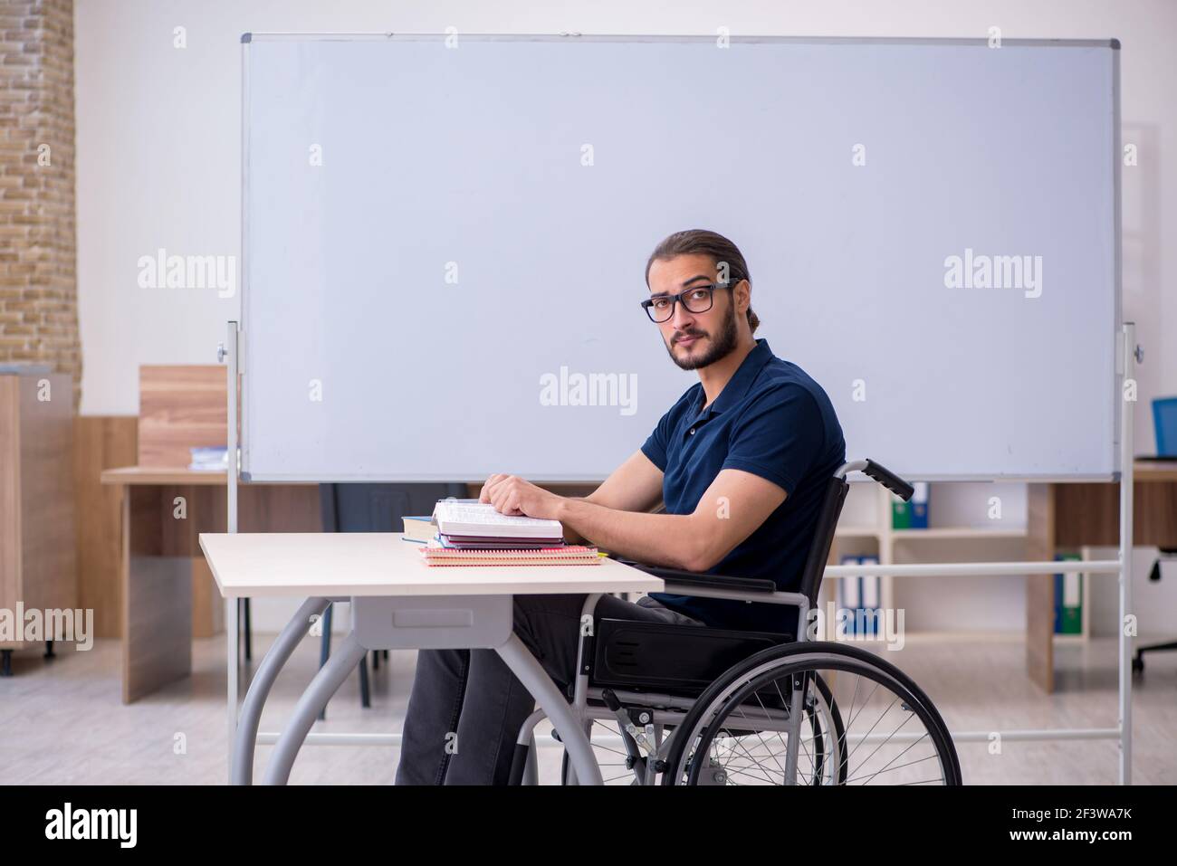 Young handicapped student in the classroom Stock Photo - Alamy