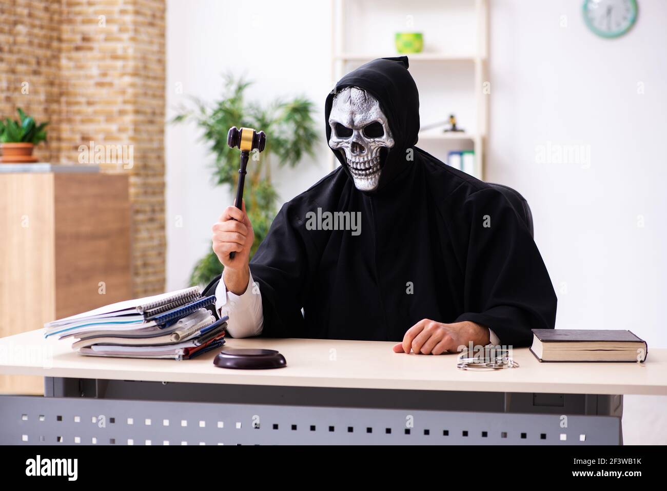 Devil judge working in the courthouse Stock Photo - Alamy