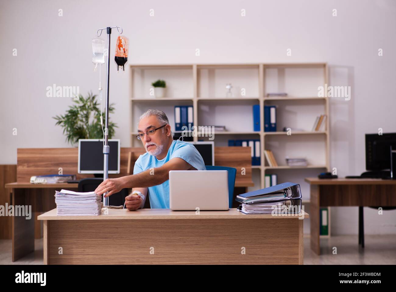 Old businessman employee in blood transfusion concept Stock Photo - Alamy