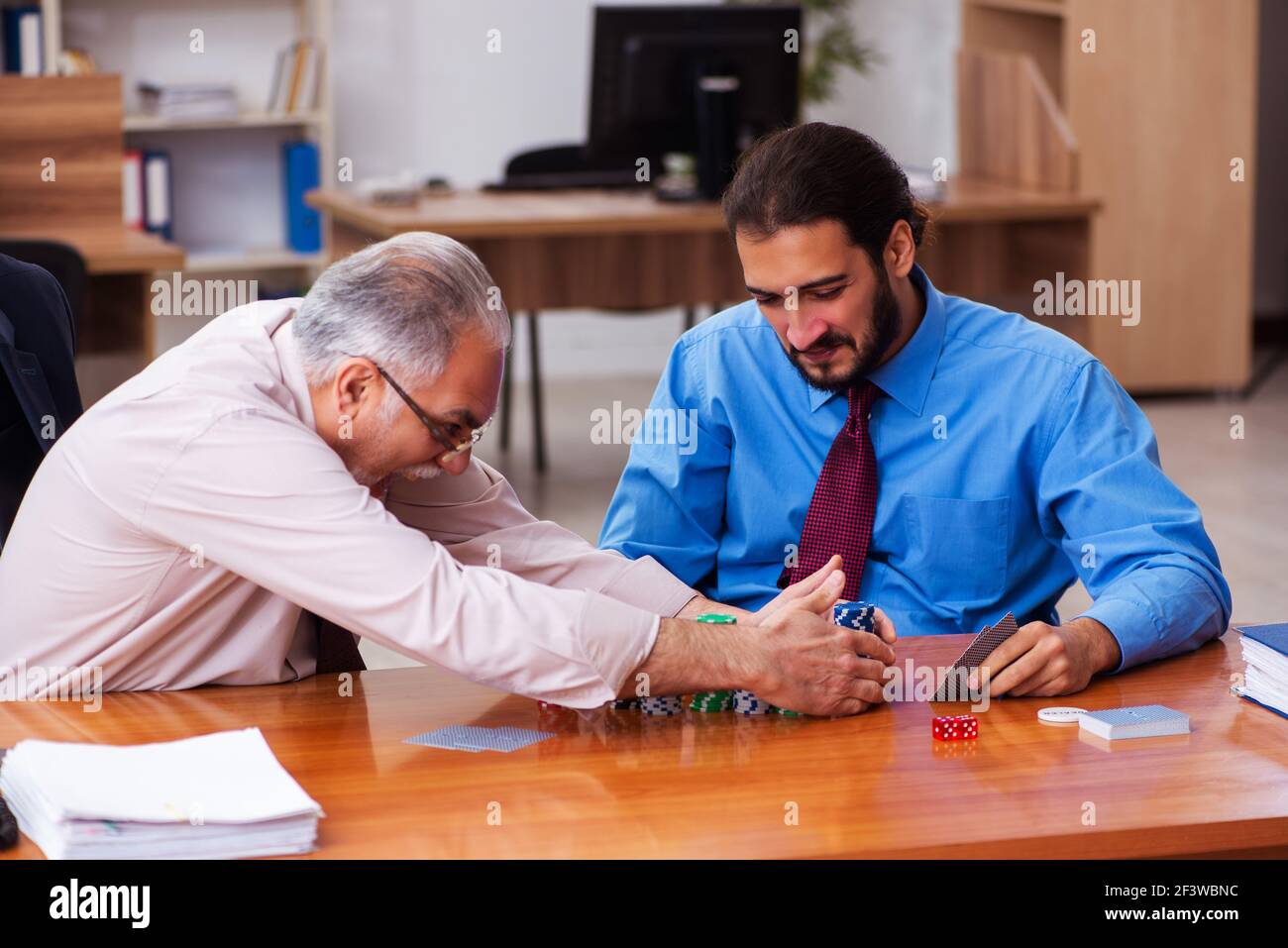 Two employees playing cards at workplace Stock Photo - Alamy