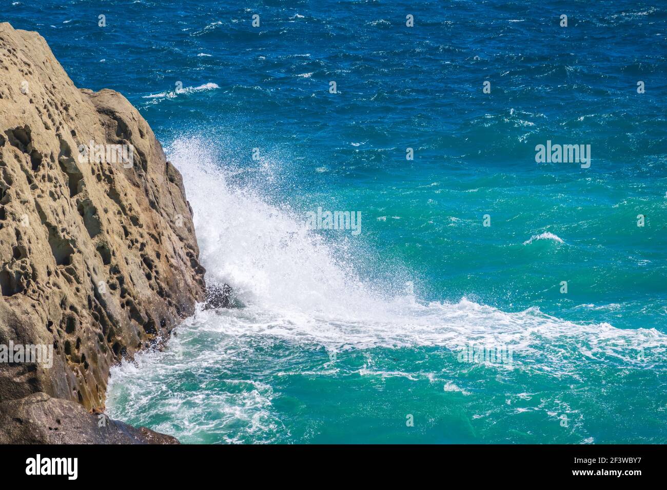 Sea water beats against rocks. Sea waves of dark water beat against the ...