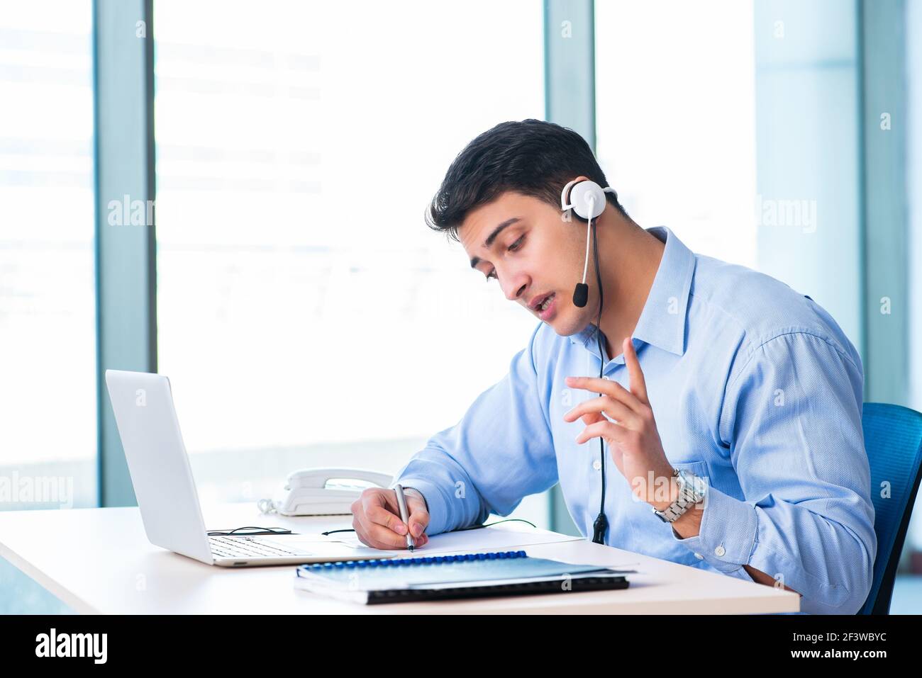 The male call-center operator in business concept Stock Photo - Alamy