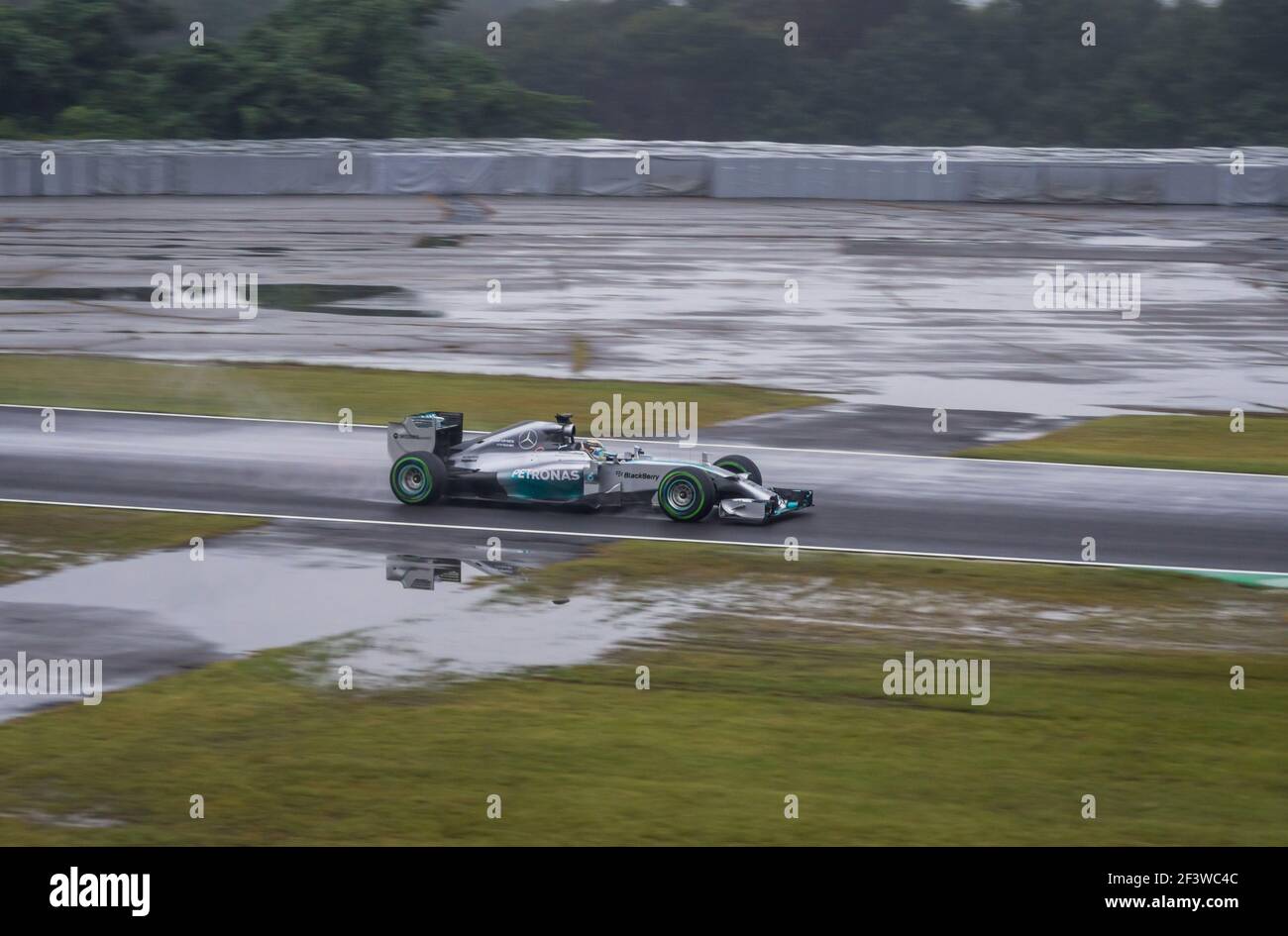Lewis Hamilton driving a Mercedes F1 W05 Hybrid at the entry to Spoon ...