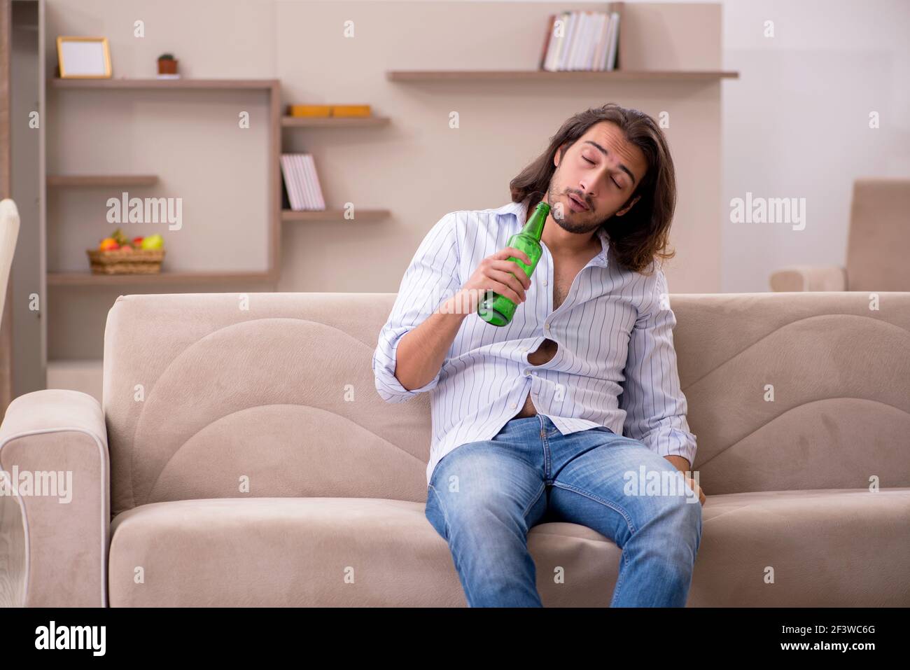 Man drinking alcohol at home Stock Photo - Alamy