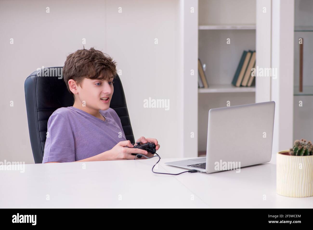 Boy playing computer games at home Stock Photo - Alamy