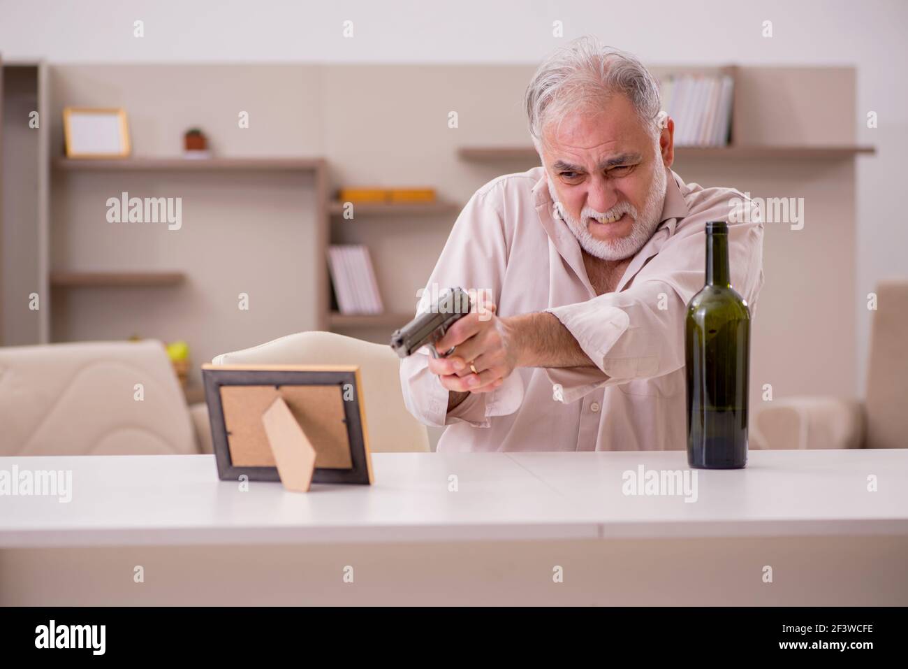 Aged male alcoholic widower committing suicide at home Stock Photo - Alamy