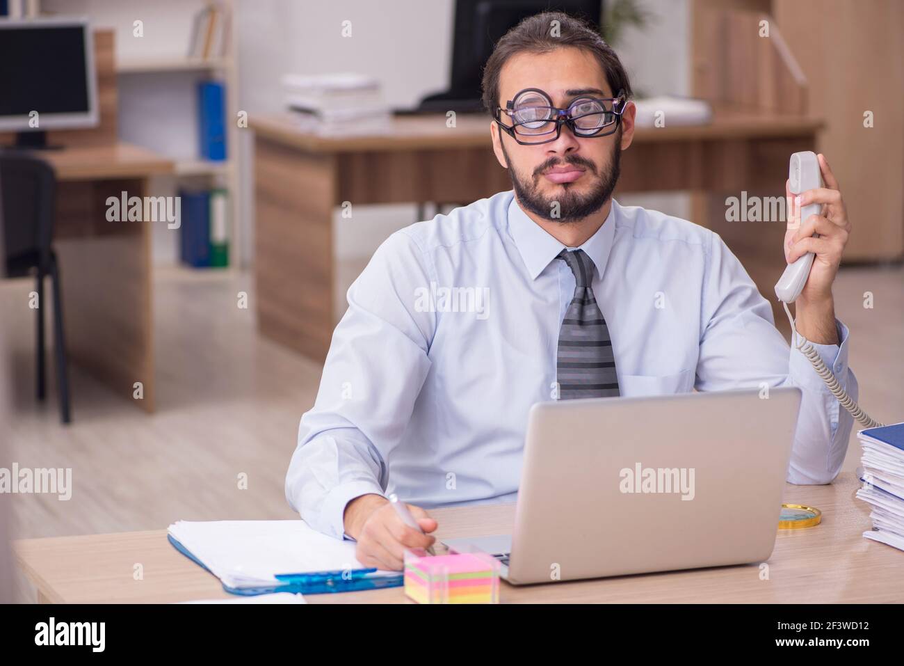 Young funny employee working at workplace Stock Photo - Alamy