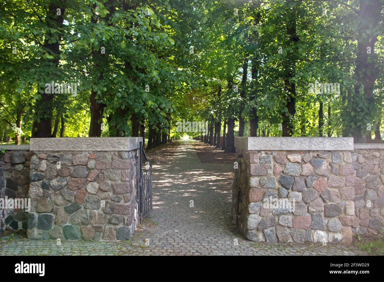 Gates entry in green park, which were made from brown granite stones ...
