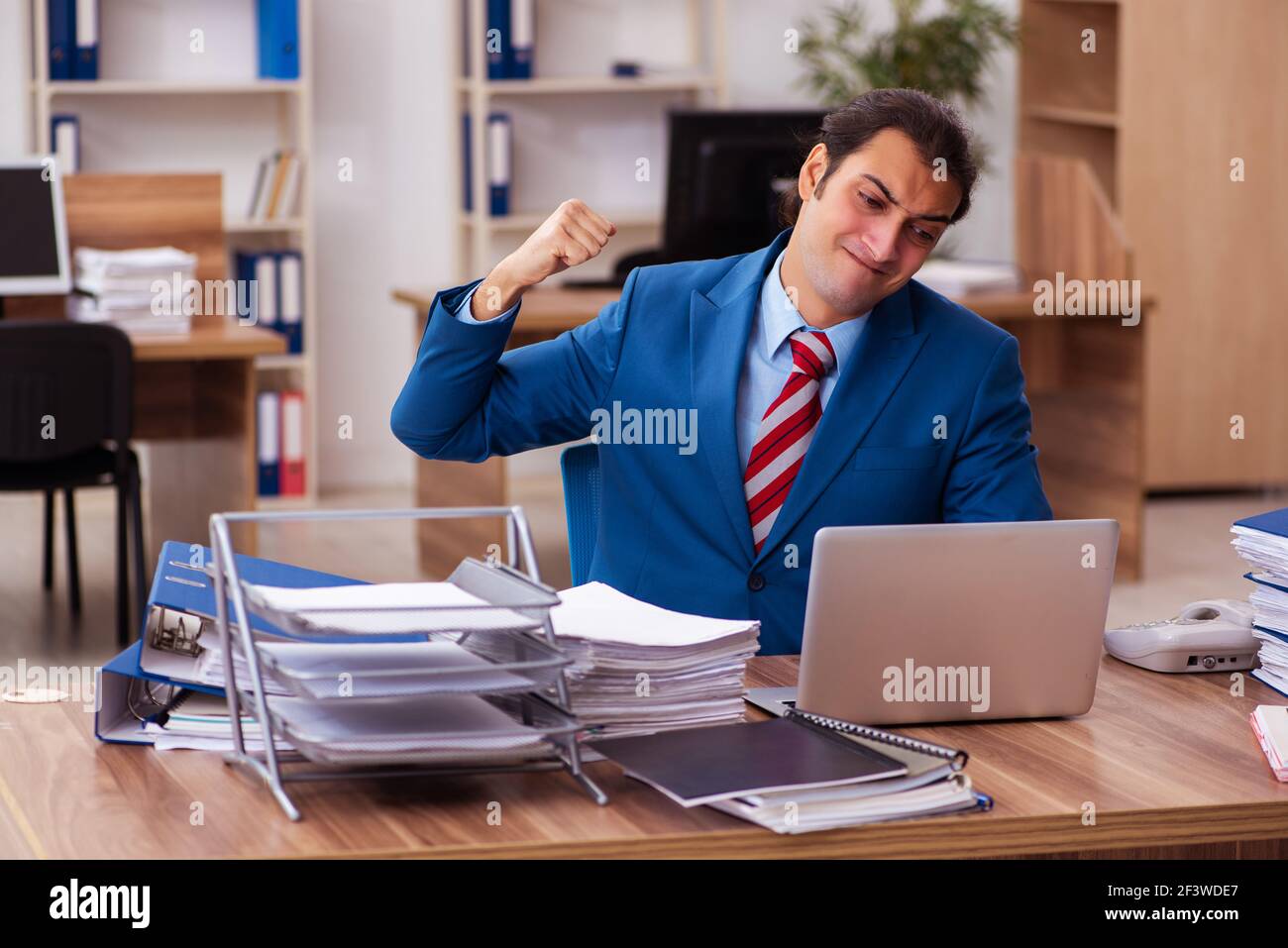 Young employee working in the office Stock Photo - Alamy
