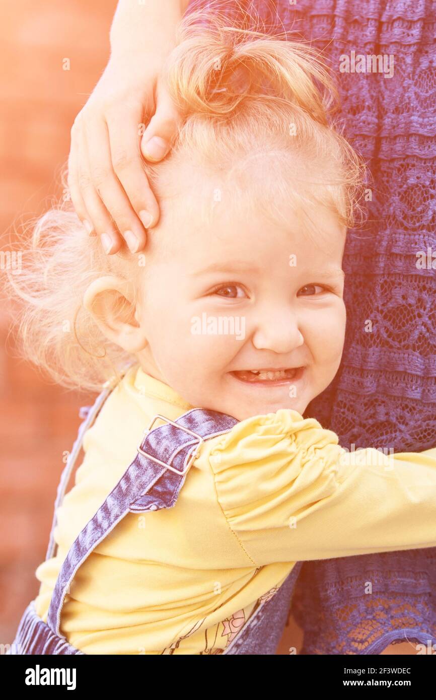 Little girl hug sister leg. Female child portrait. Happy people Stock ...