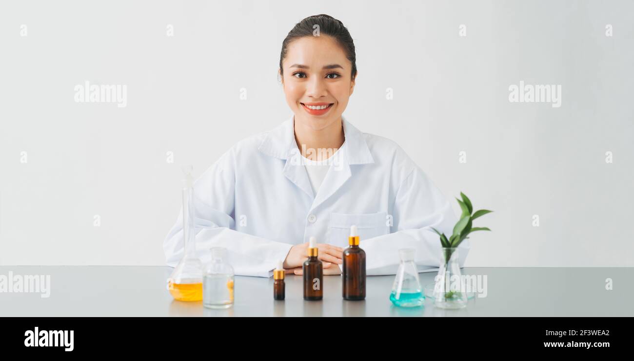 scientist or doctor making herbal medicine with herb leaves , capsule ...