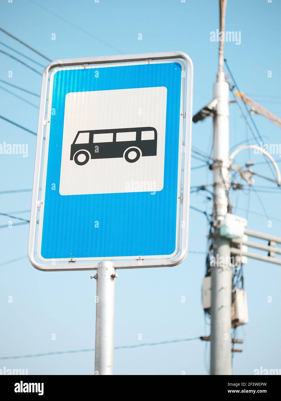 Bus stop sign in the street. Road sign a pylon Stock Photo - Alamy