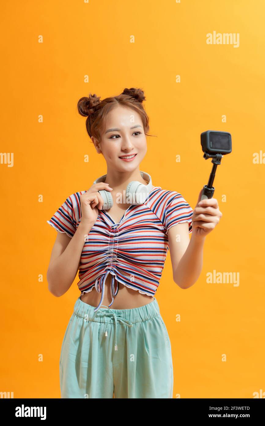 A female hand hold small Action camera often used in extreme action ...