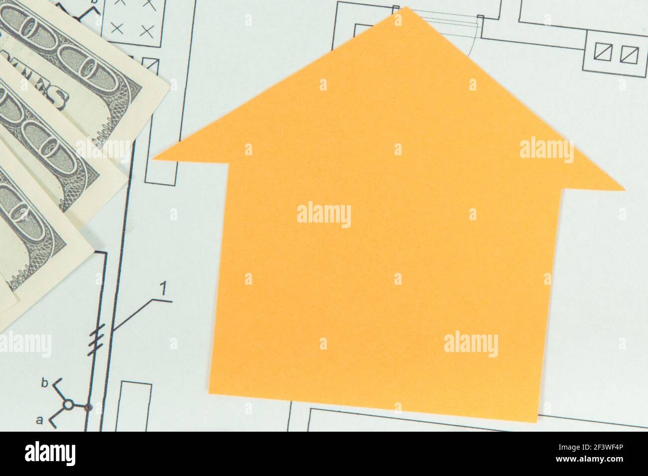 Home shape and money on electrical construction drawing, concept of ...