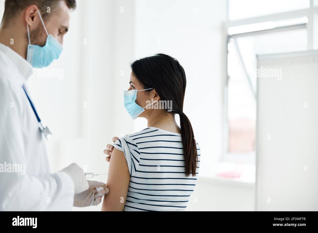 male doctor giving a shot in the shoulder health injection covid Stock ...