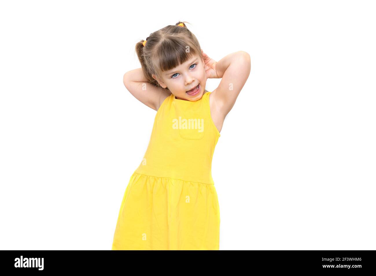 emotional little girl in yellow dress posing on white background Stock ...