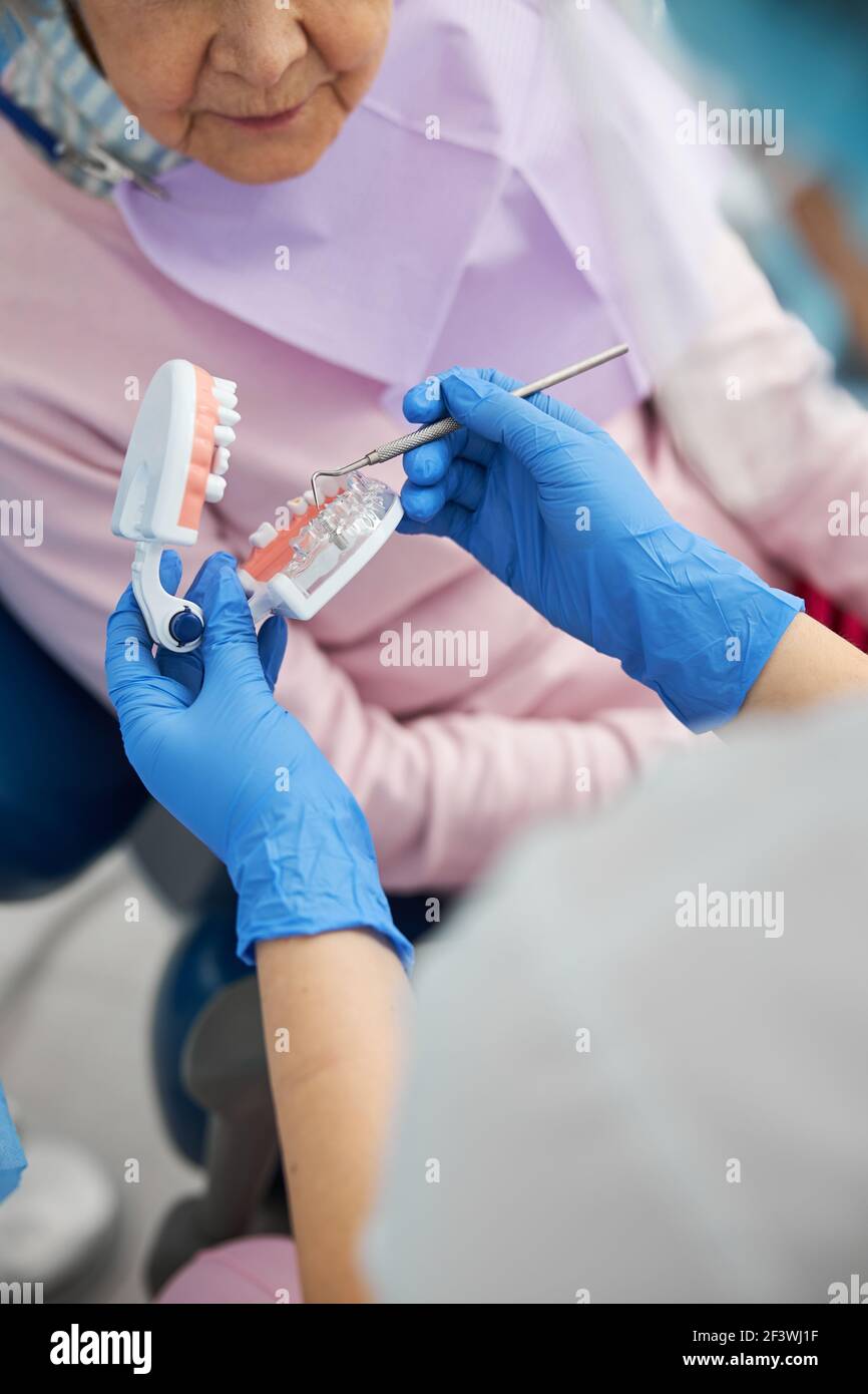 Plastic teeth model touched with dental probe Stock Photo - Alamy