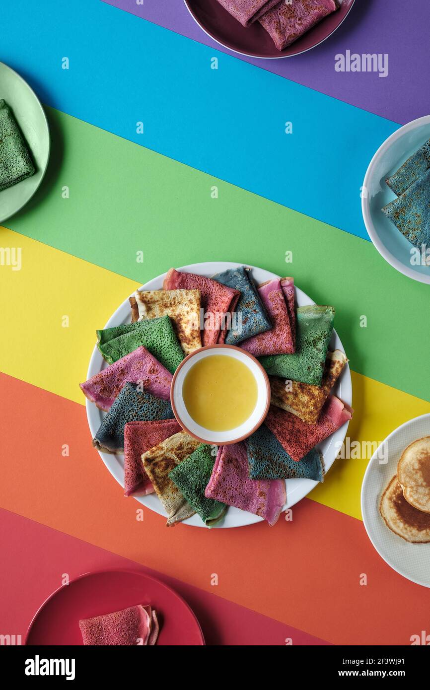 Rainbow pancakes, different color crepes. Spinach, beetroot powder ...