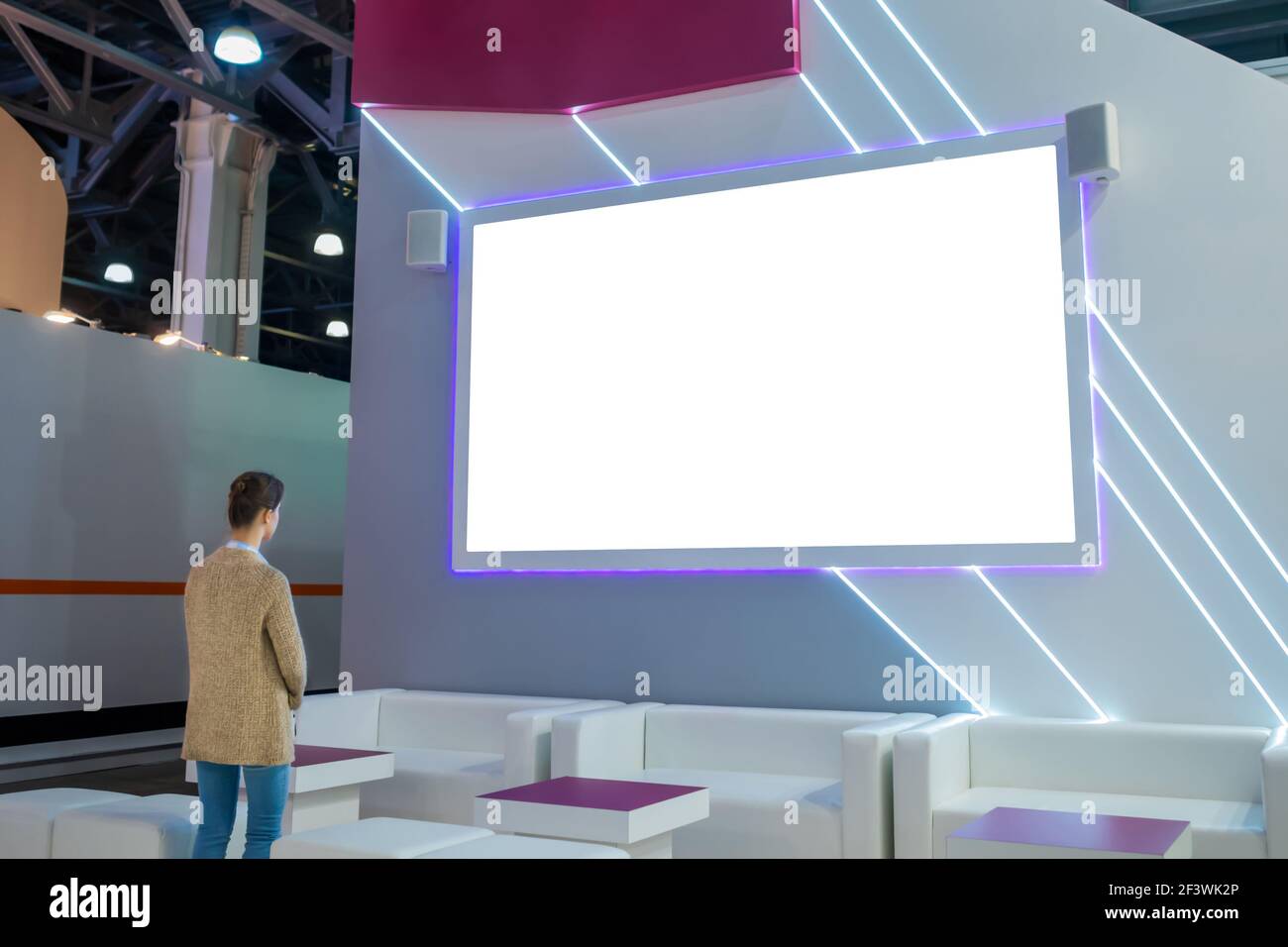 Mockup image: woman looking at blank large white interactive wall ...
