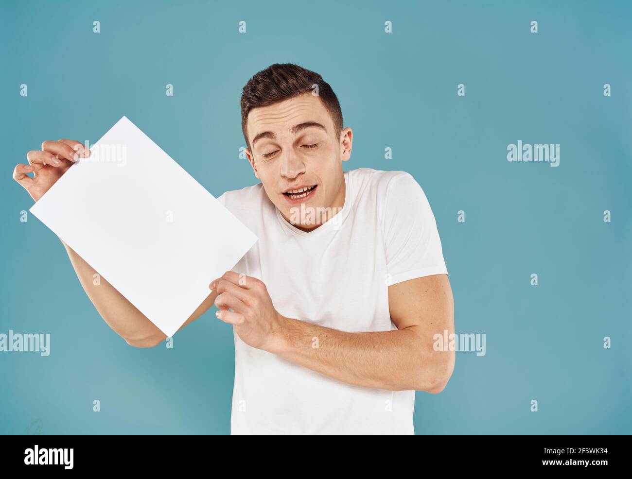 Man Holding Flyer Poster mockup blue background cropped view Stock ...