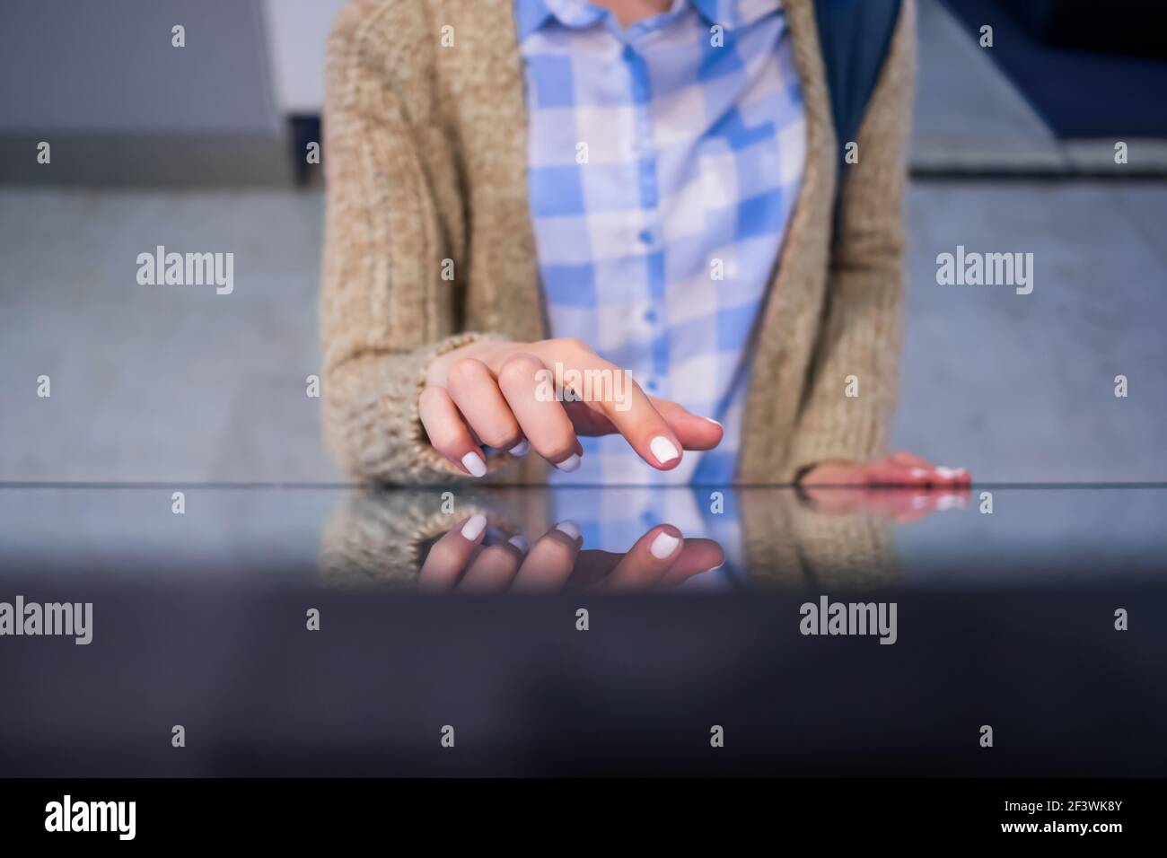 Woman using interactive touchscreen display of electronic multimedia ...