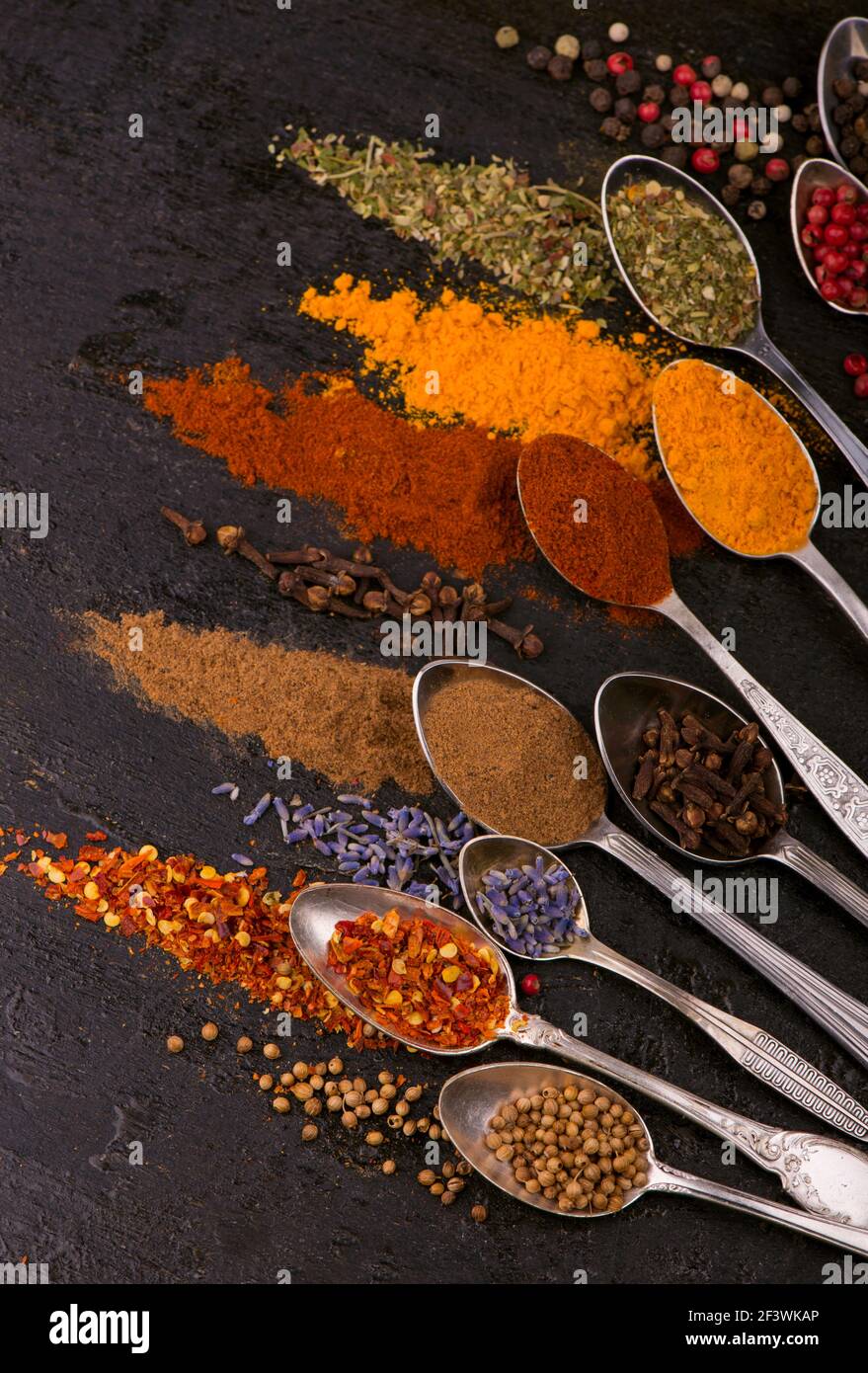 Spices and condiments for cooking on a black background Stock Photo - Alamy