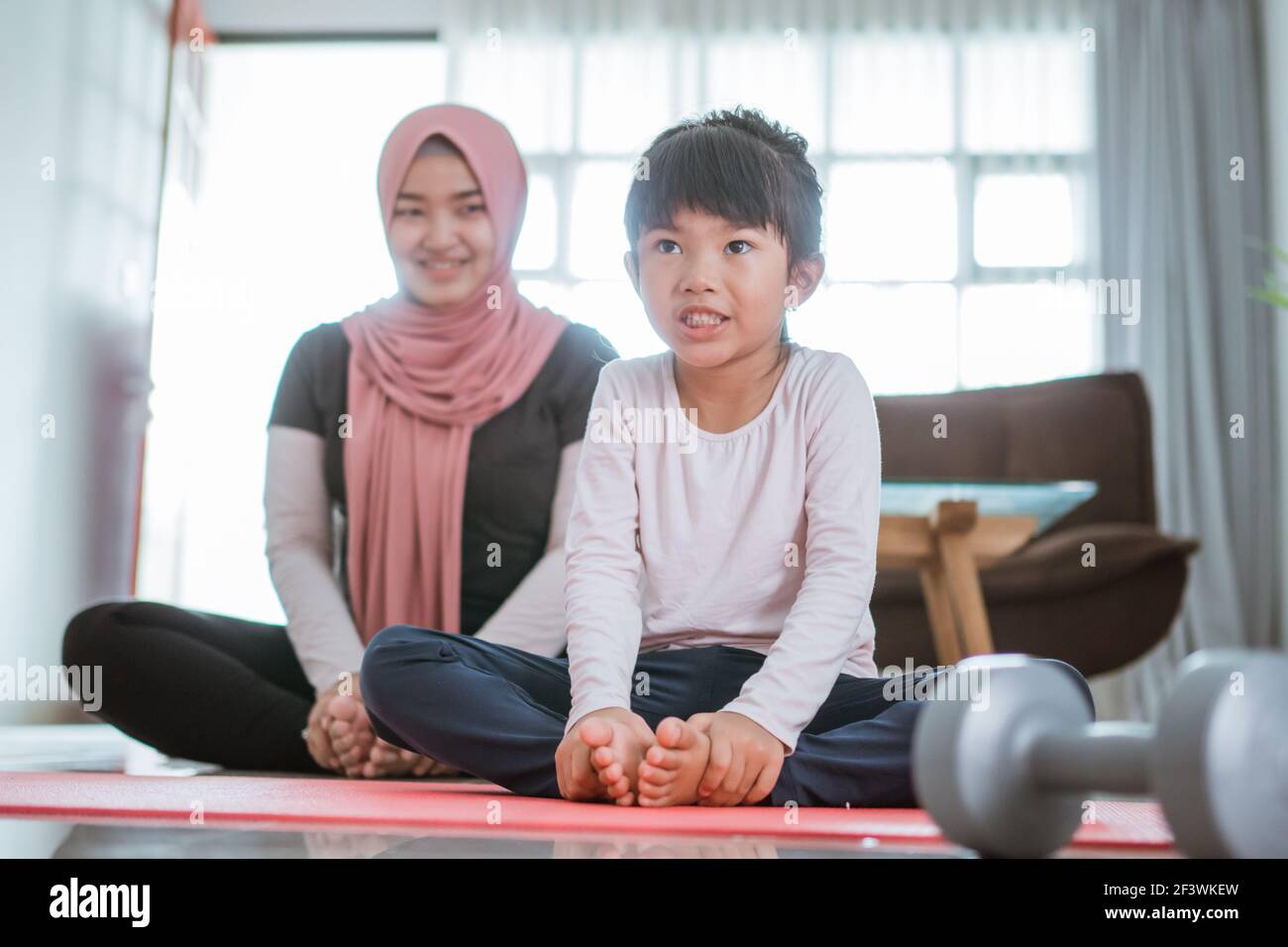 muslim woman doing sport and exercise with daughter at home Stock Photo ...