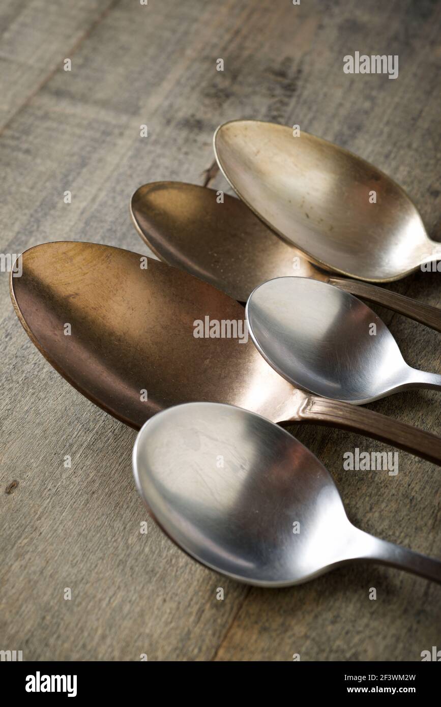 Collection of spoons on a wood table Stock Photo - Alamy