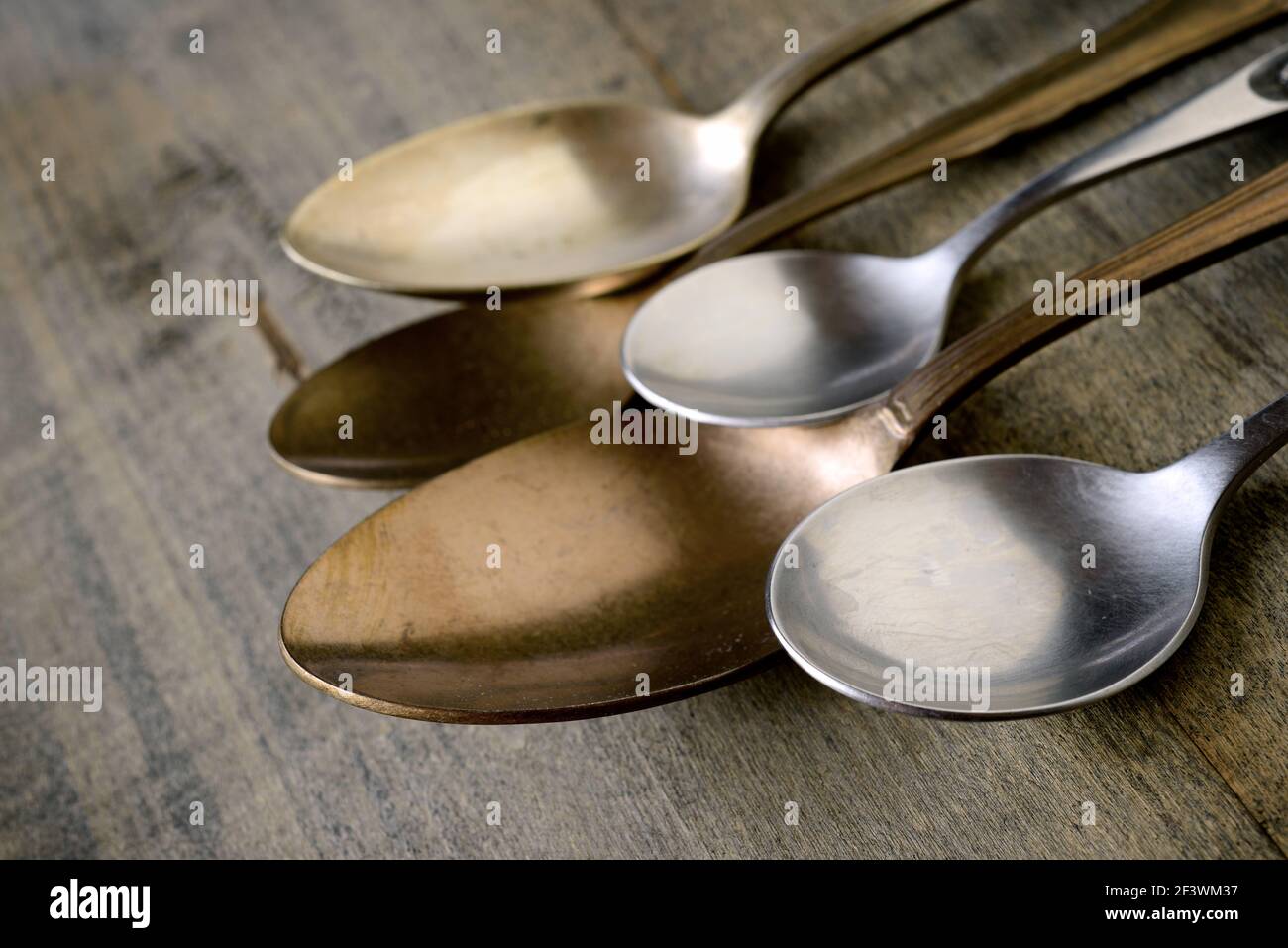 Collection of spoons on a wood table Stock Photo - Alamy