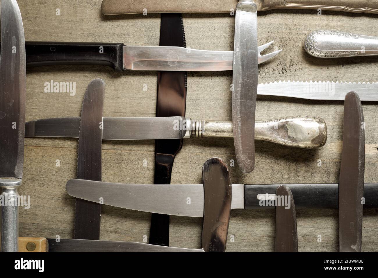 Collection of knifes on a wood table Stock Photo - Alamy