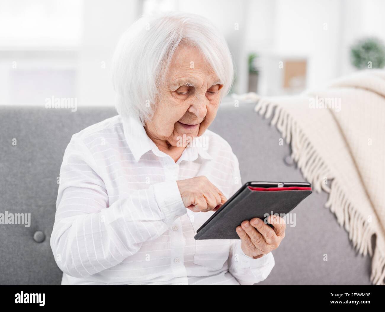 Elderly woman with tablet Stock Photo - Alamy