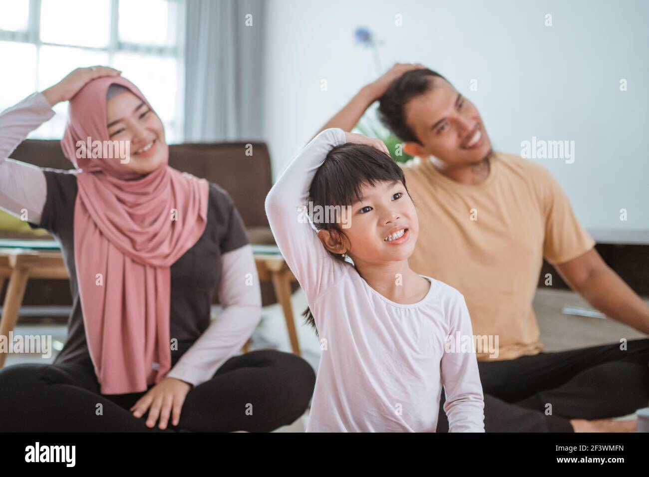 Portrait of healthy muslim family workout at home together Stock Photo ...