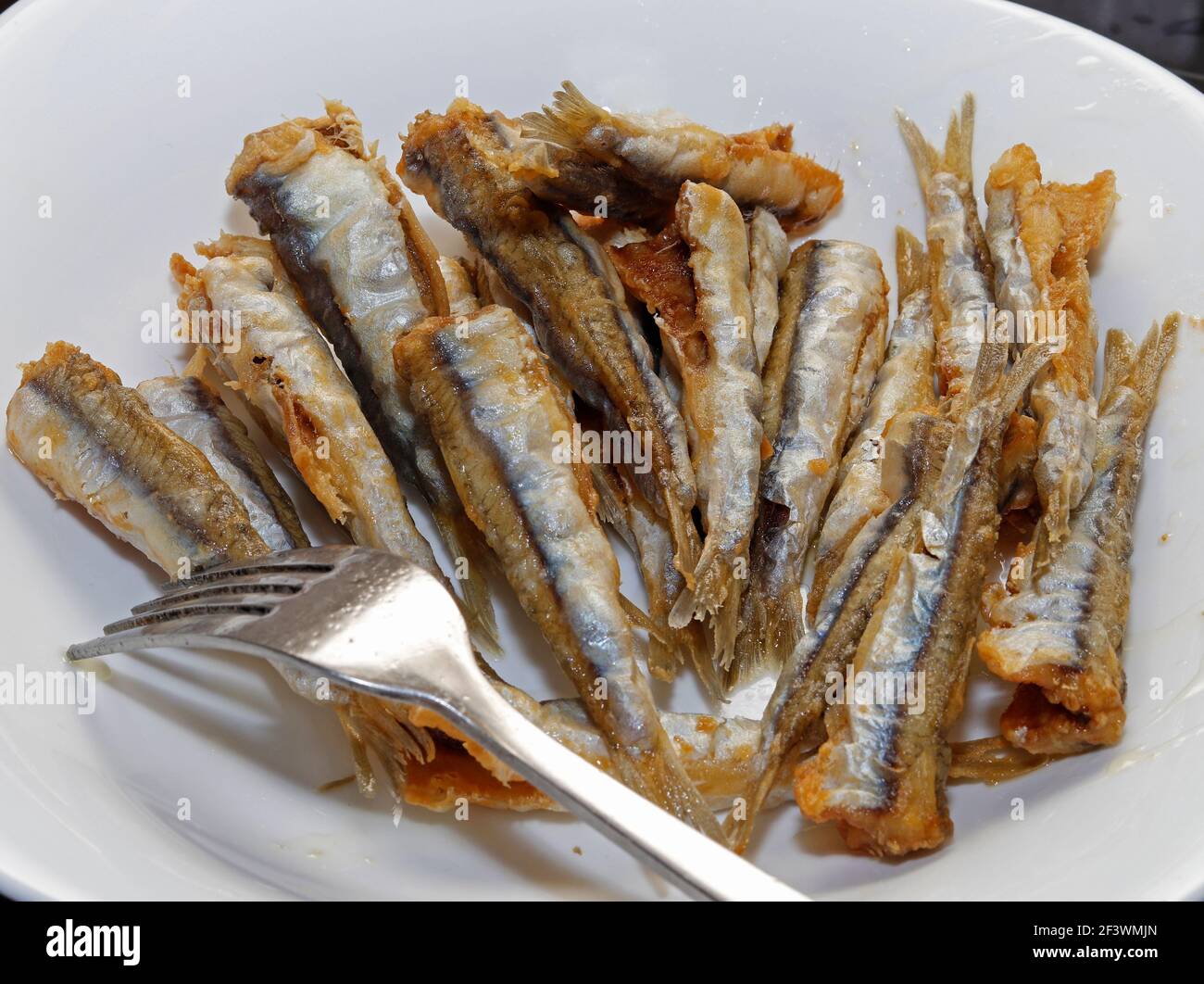 Close up of fried anchovies in a dish. Greek traditional dish Stock ...