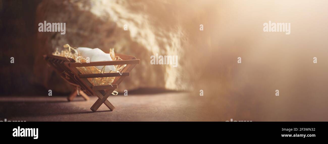 Wooden manger and star of Bethlehem in cave, nativity scene background ...